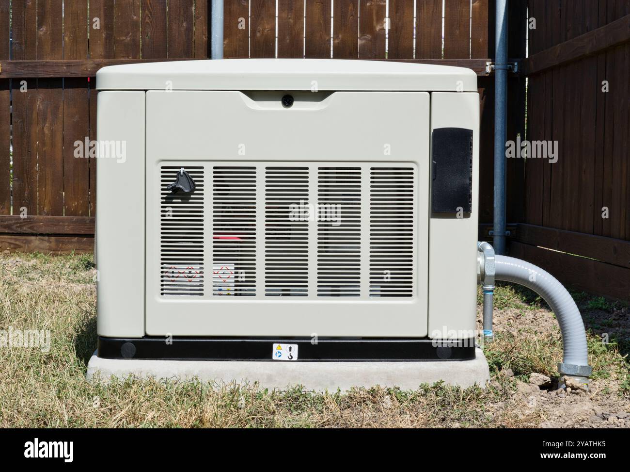 Standby home generator set in residential backyard, emergency backup ...