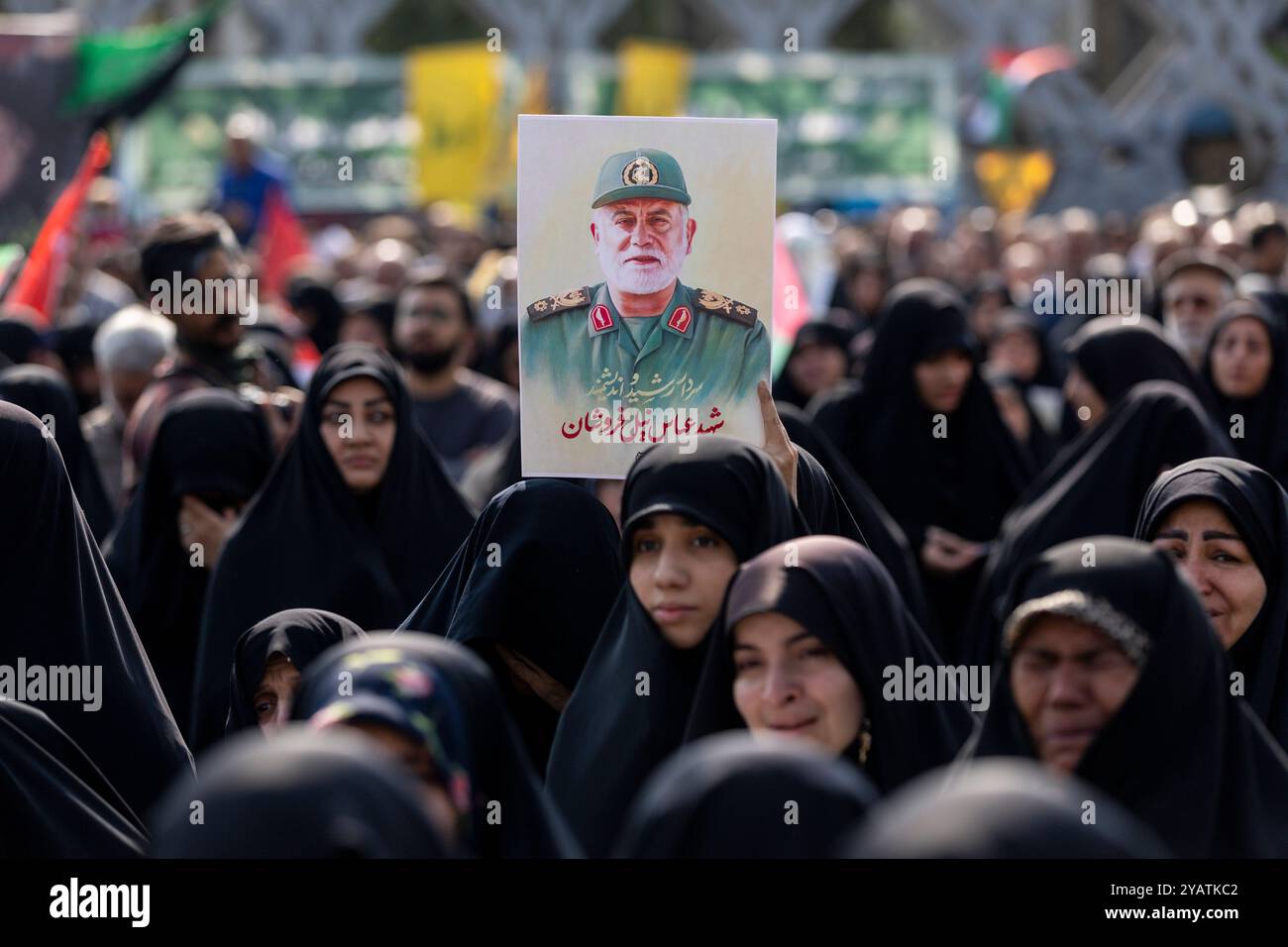 An Iranian woman holds a poster of the late Revolutionary Guard Gen ...