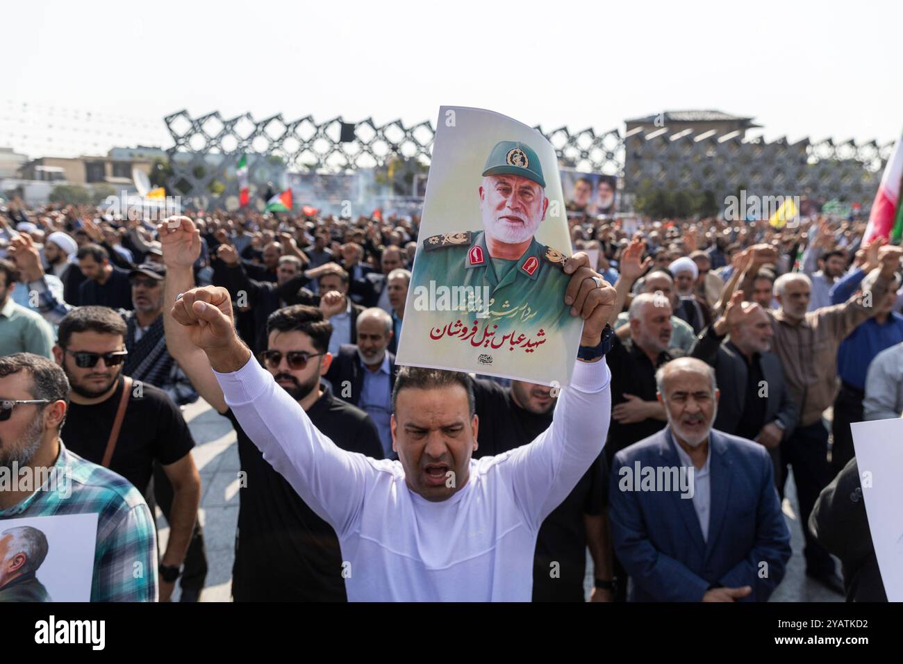 An Iranian man holds a poster of the late Revolutionary Guard Gen ...
