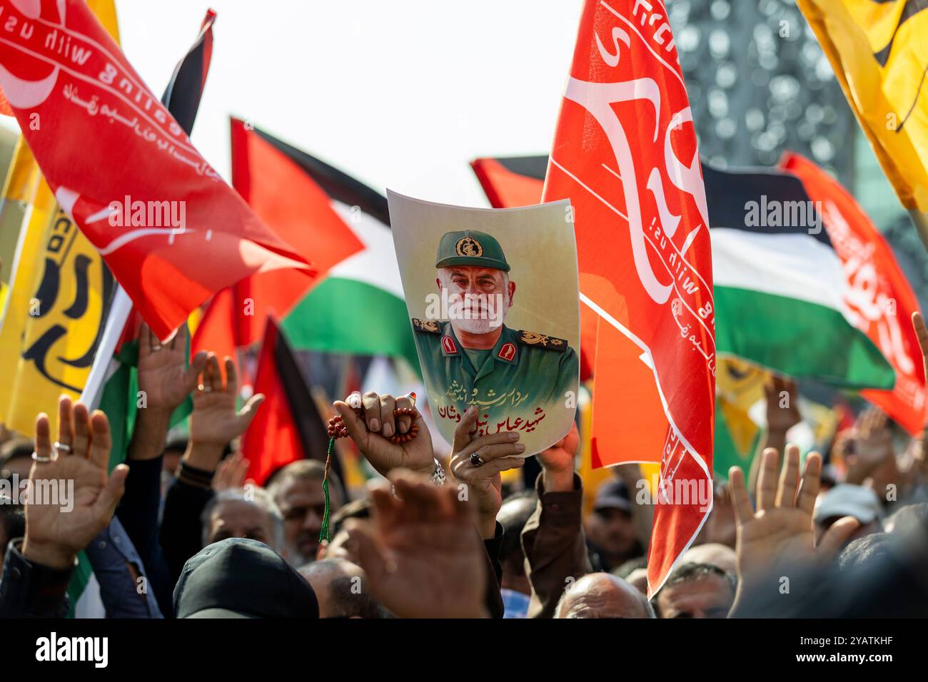 An Iranian man holds a poster of the late Revolutionary Guard Gen ...