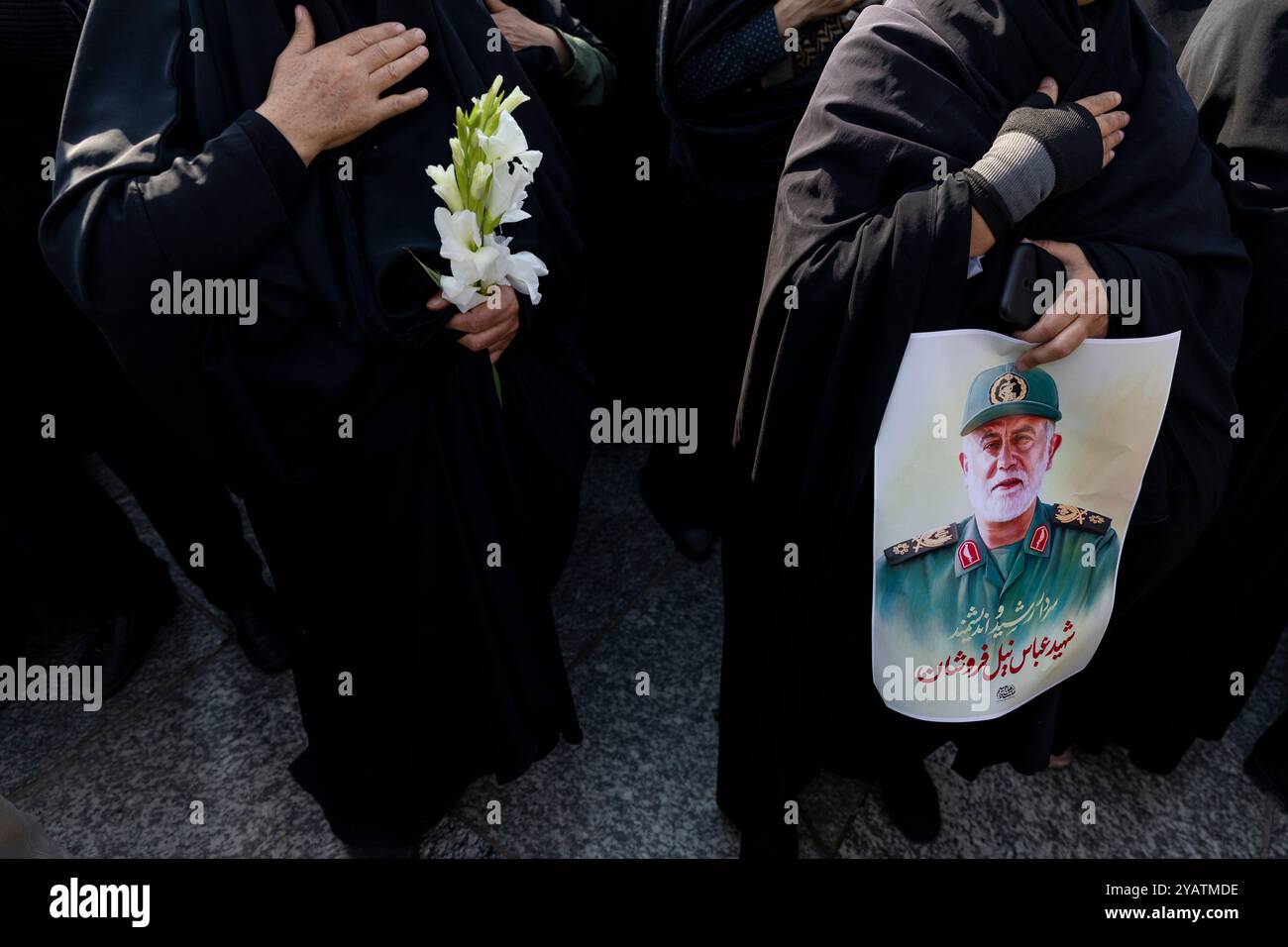An Iranian woman holds a poster of the late Revolutionary Guard Gen ...