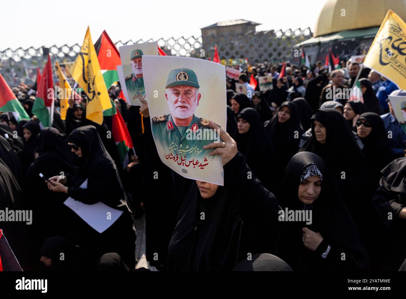 An Iranian woman holds a poster of the late Revolutionary Guard Gen ...