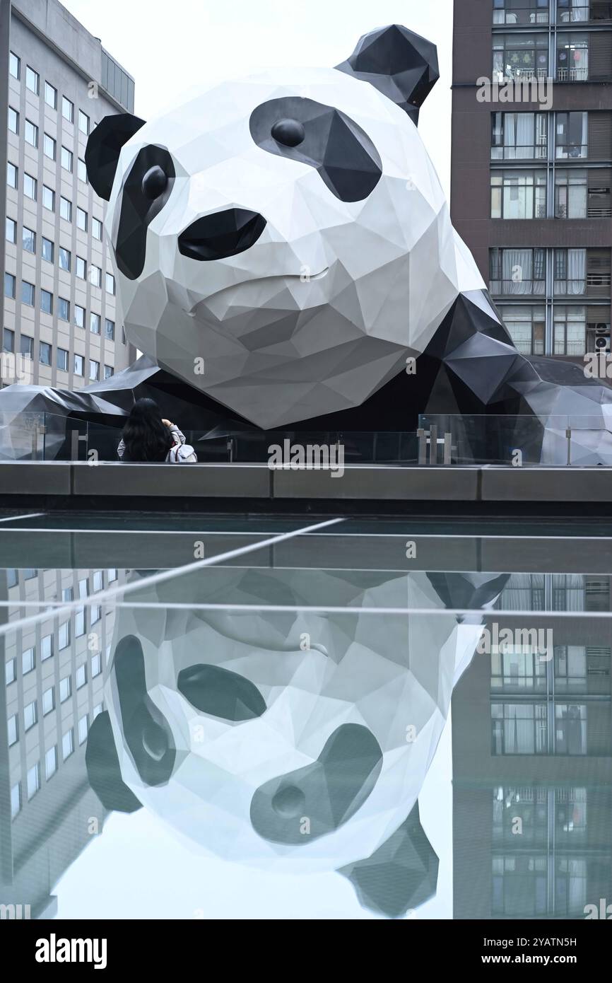 CHENGDU, CHINA - OCTOBER 15, 2024 - People line up to take a photo with ...