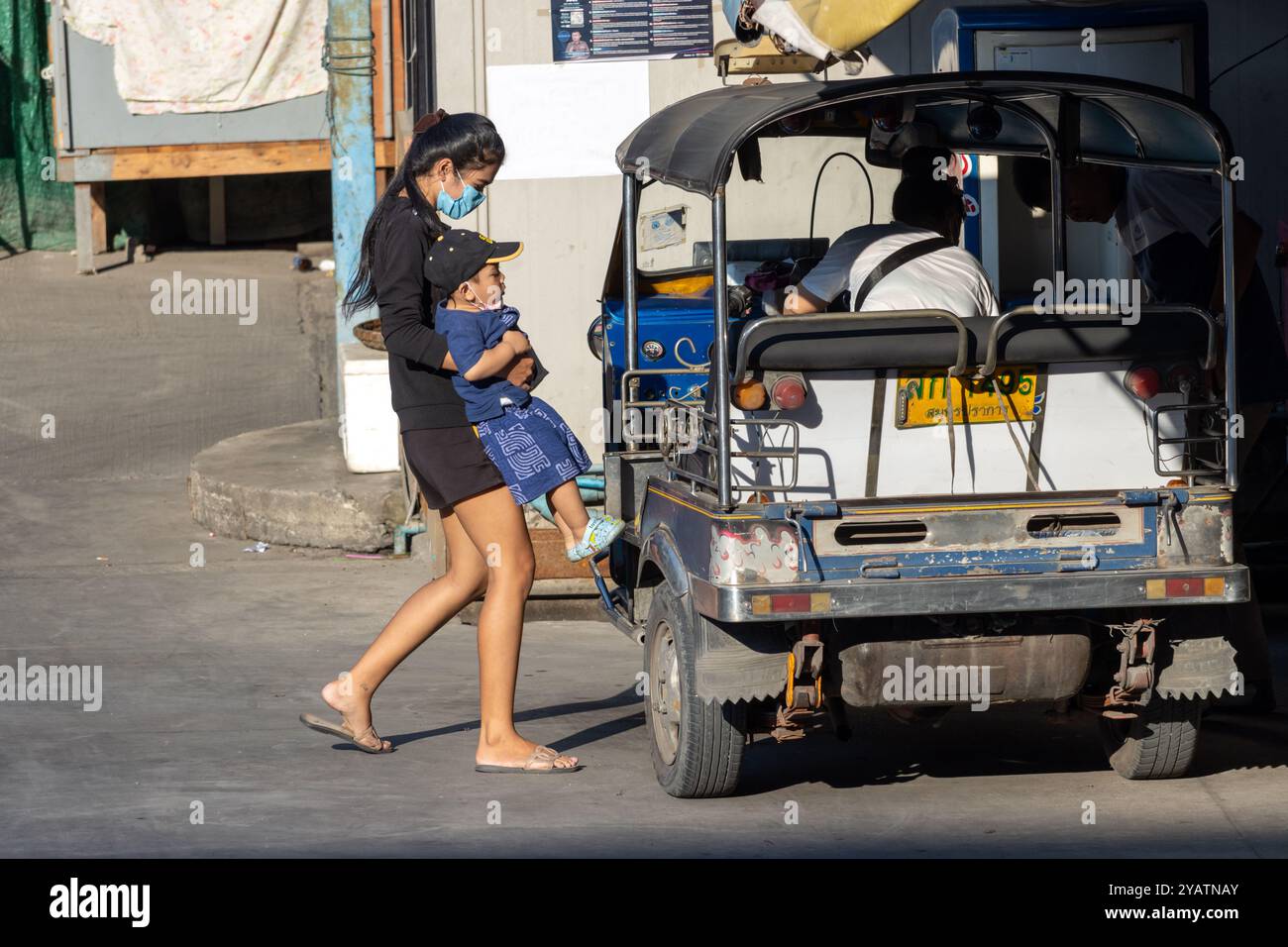SAMUT PRAKAN, THAILAND, FEB 08 2023, A woman with a small boy gets into ...