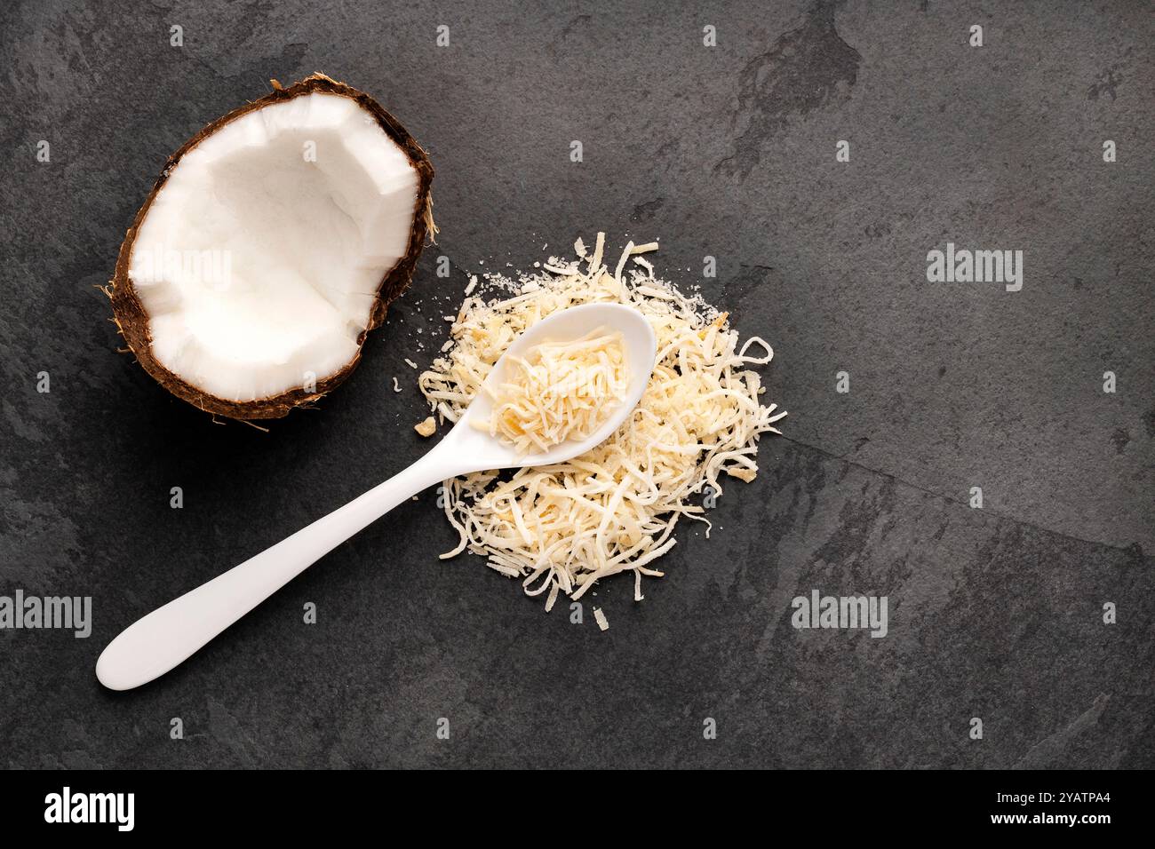 Grated coconut with dehydrated sugar on the spoon - Cocos nucifera ...