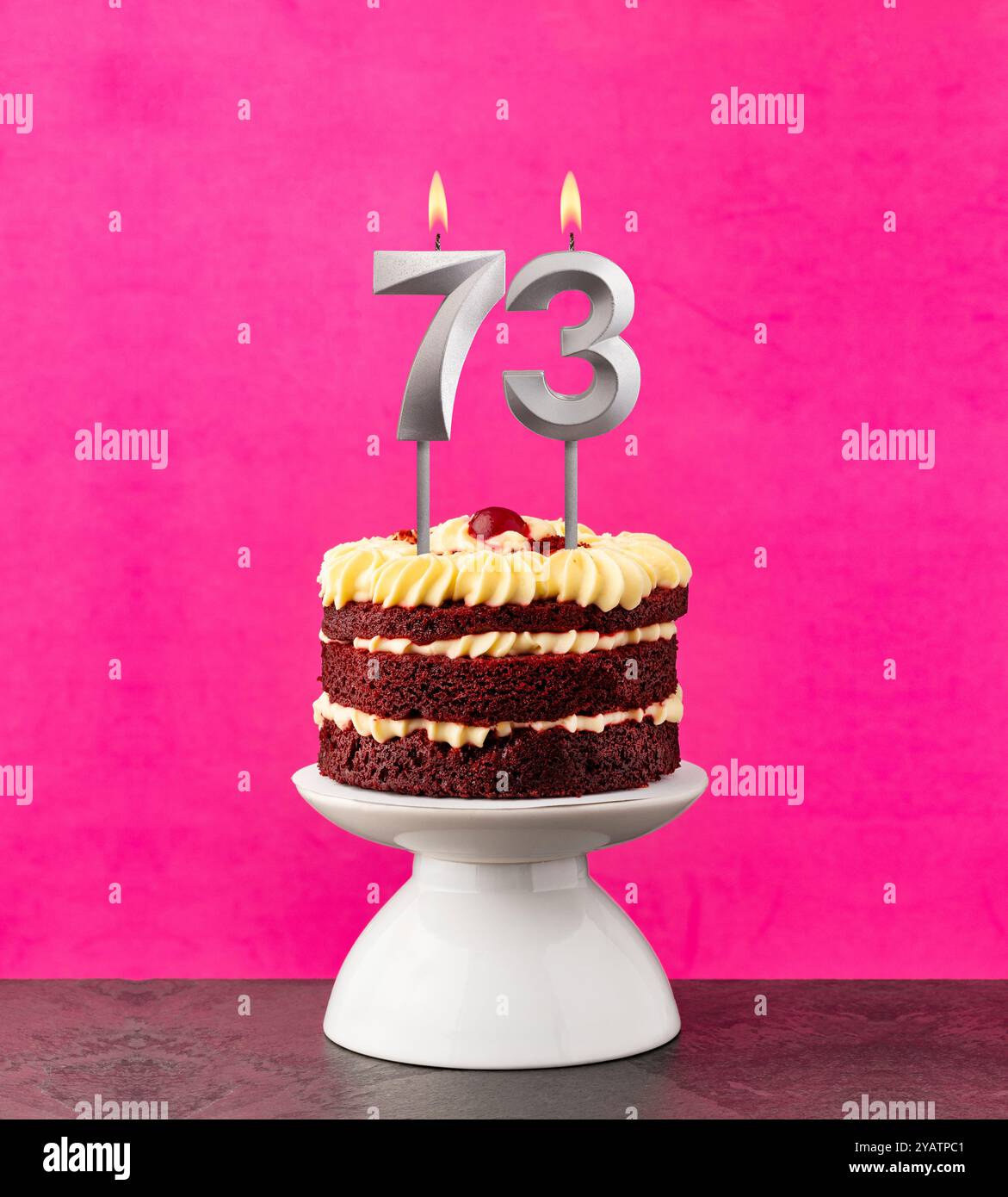 Birthday cake with number 73 candle - Red velvet on a fuchsia ...
