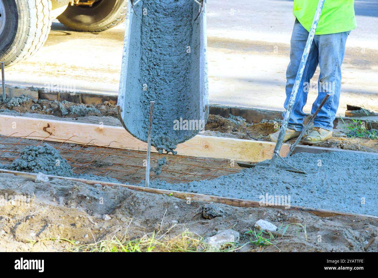 Concrete mixer truck is pouring fresh concrete onto reinforced bars for ...
