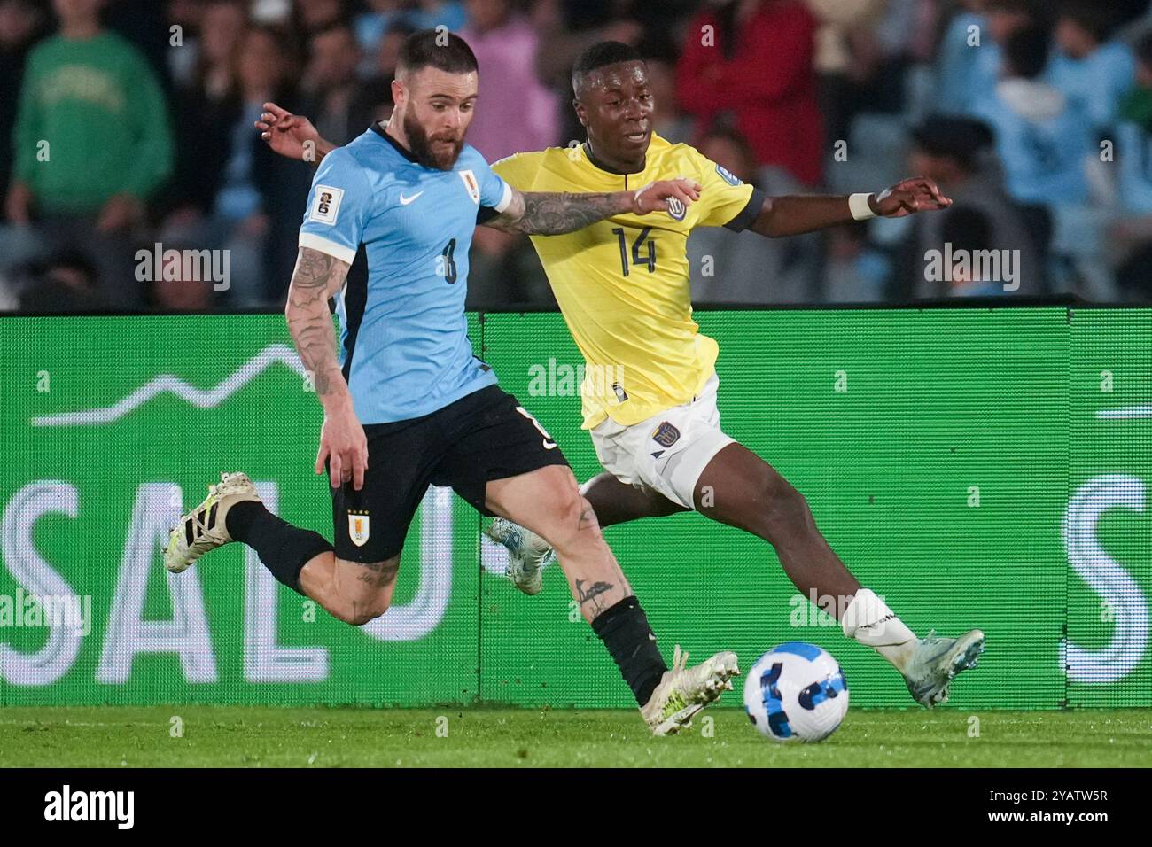 Uruguay's Nahitan Nandez, left, and Ecuador's Alan Minda compete for ...