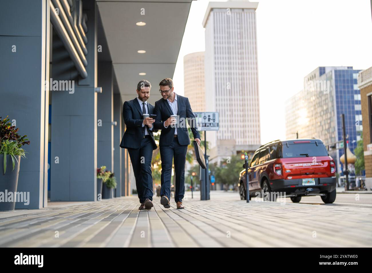 Business men talking. Walking and talking two business men. Colleague ...