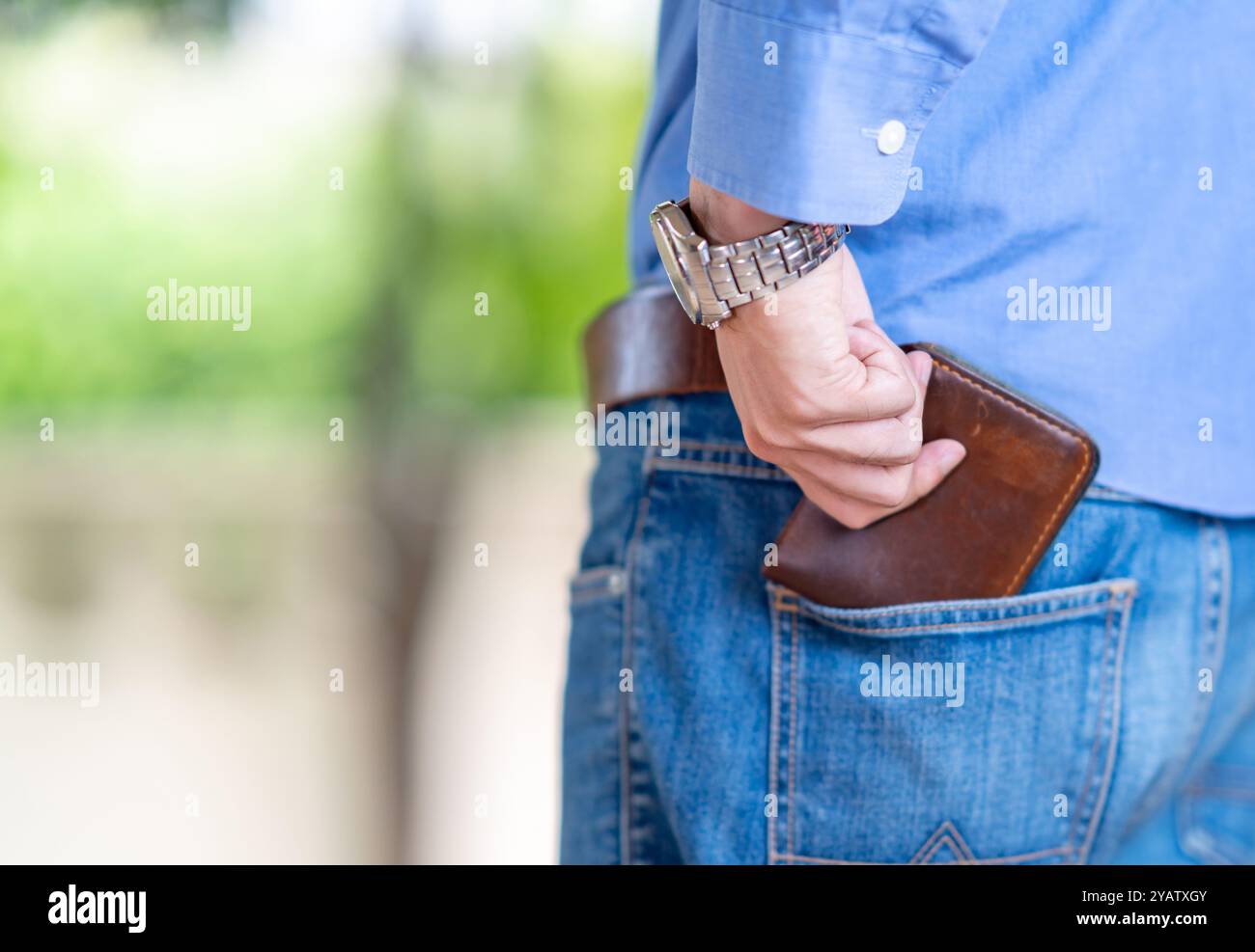 Putting wallet in back side pocket of jean on blur background Stock ...