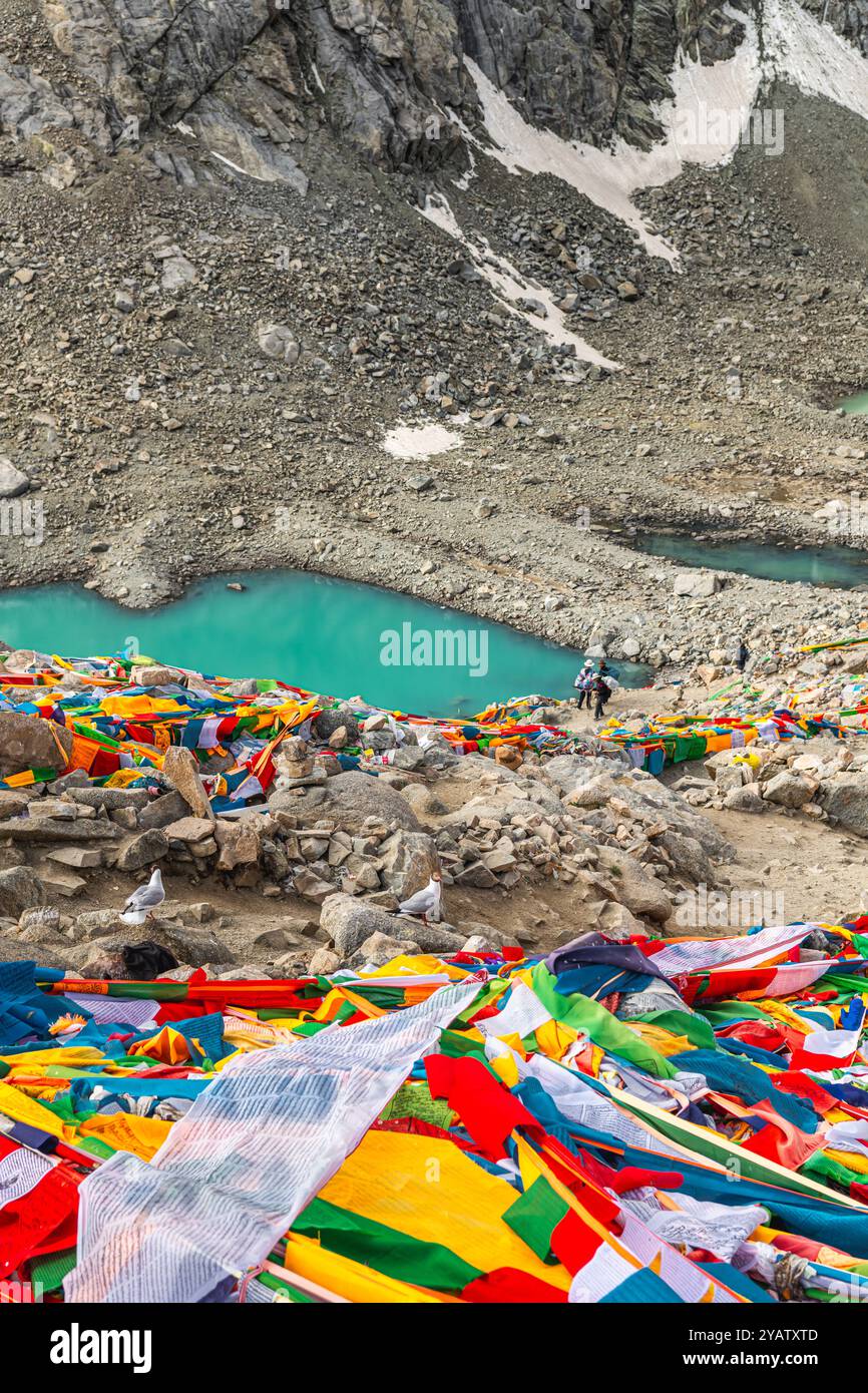 Tibetan praying flags at the Gauri Kund mountain lake during the ritual ...