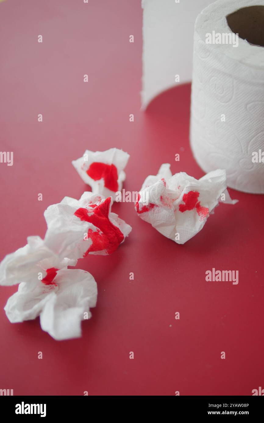 Blood on the tissues on light green background Stock Photo - Alamy
