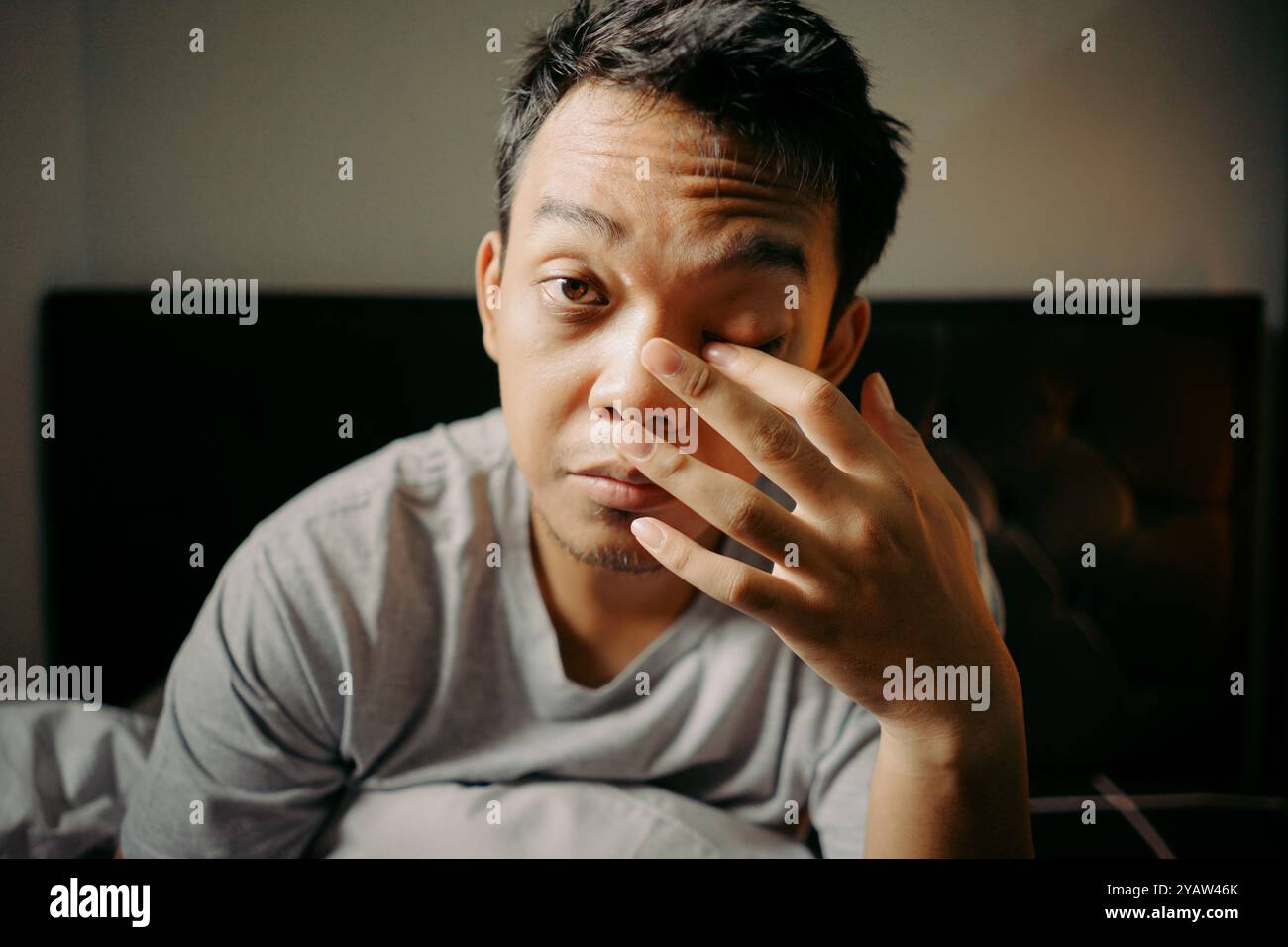 Man rubbing eye hand hi-res stock photography and images - Alamy