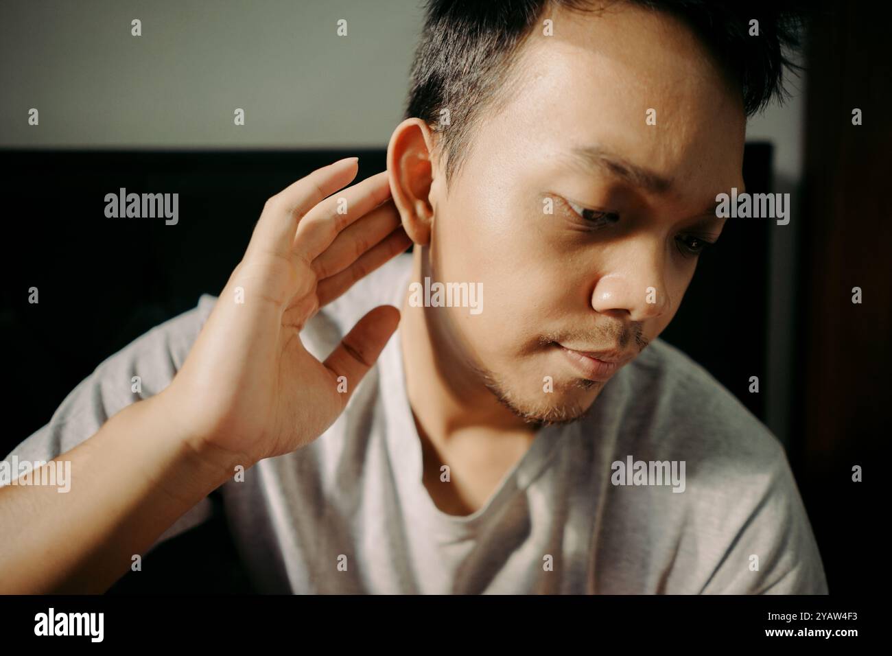 A man touching his ear using fingers hand examining health Stock Photo ...