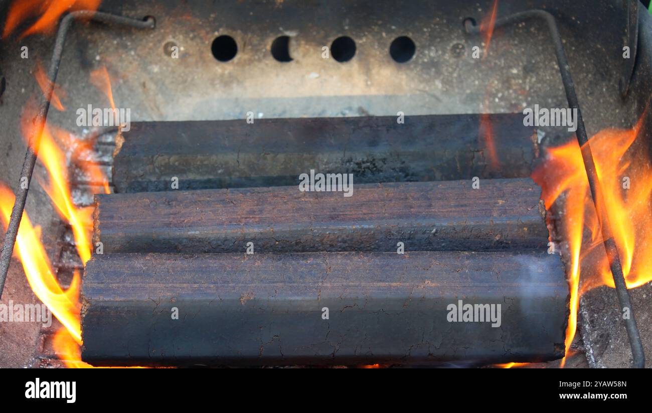 wooden briquettes be on fire. close-up. background Stock Photo - Alamy