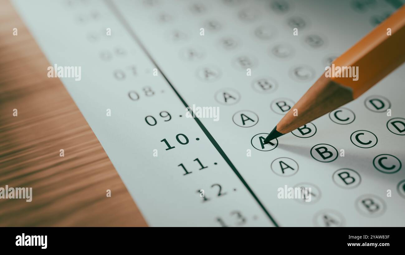 Marking the answer sheet with a pencil while taking a exam at school ...