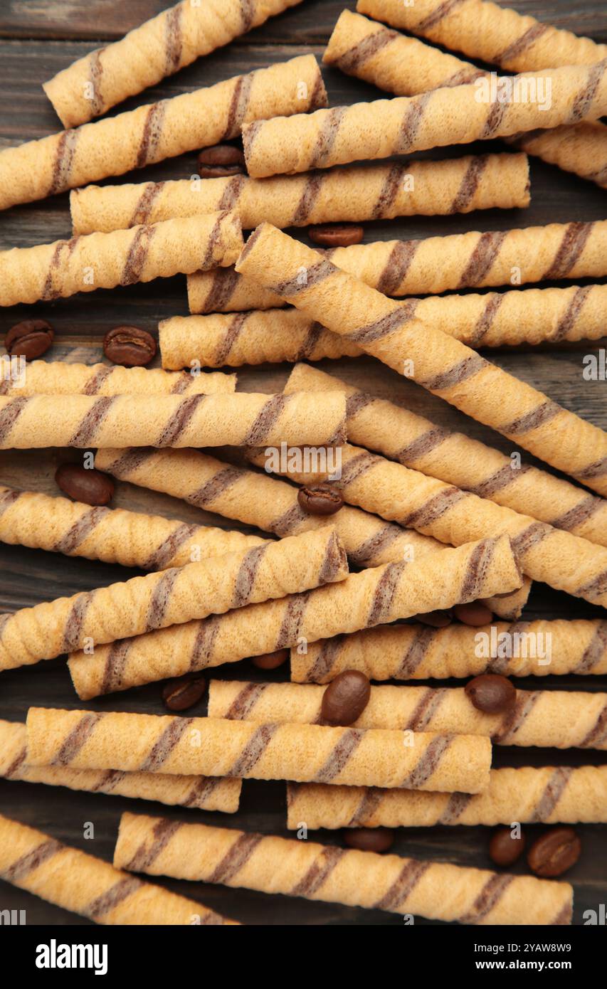 Close-up of striped wafer rolls on dark background. Background or ...