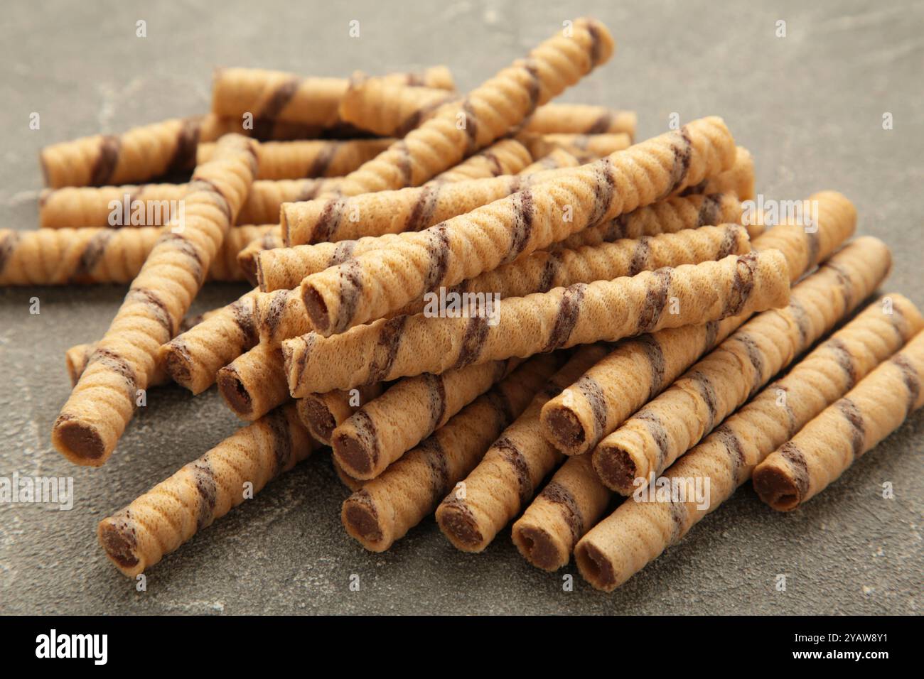 Coffee wafer stick roll with coffee cream on grey background. Space for ...