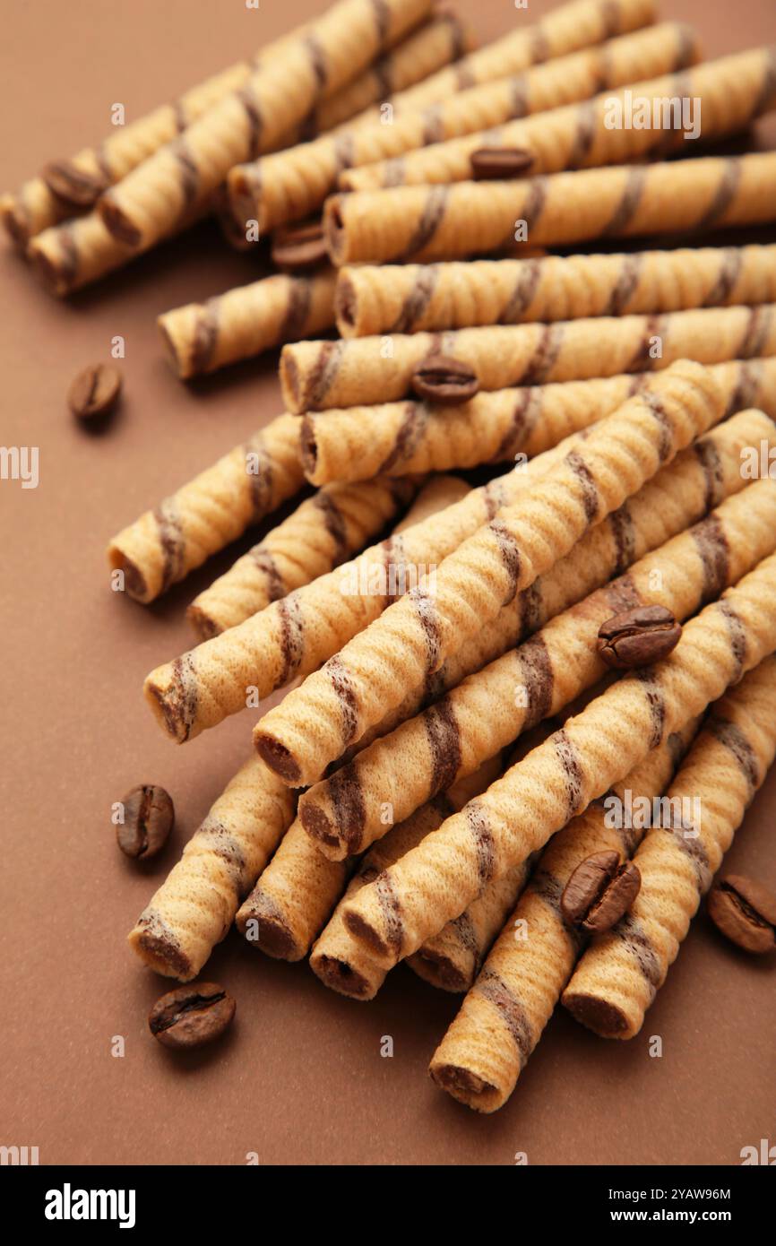 Coffee wafer stick roll with coffee cream on brown background. Top view ...