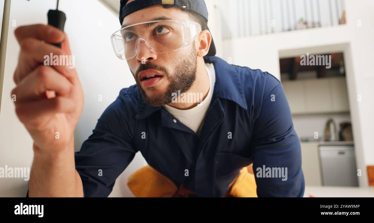 Plumber, man and screwdriver for pipe in kitchen with home maintenance ...