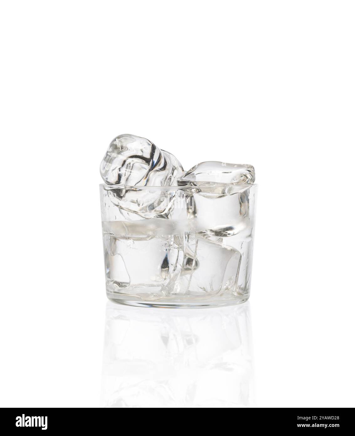 Still life of a large glass with ice and grappa liqueur, on a white ...