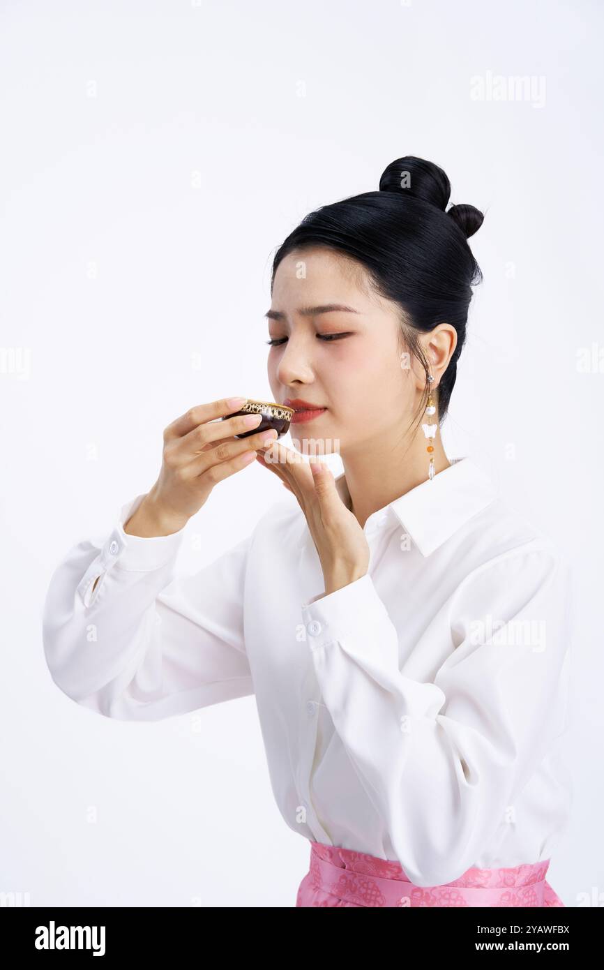 A young Chinese woman drinking tea under a flower tree Stock Photo - Alamy