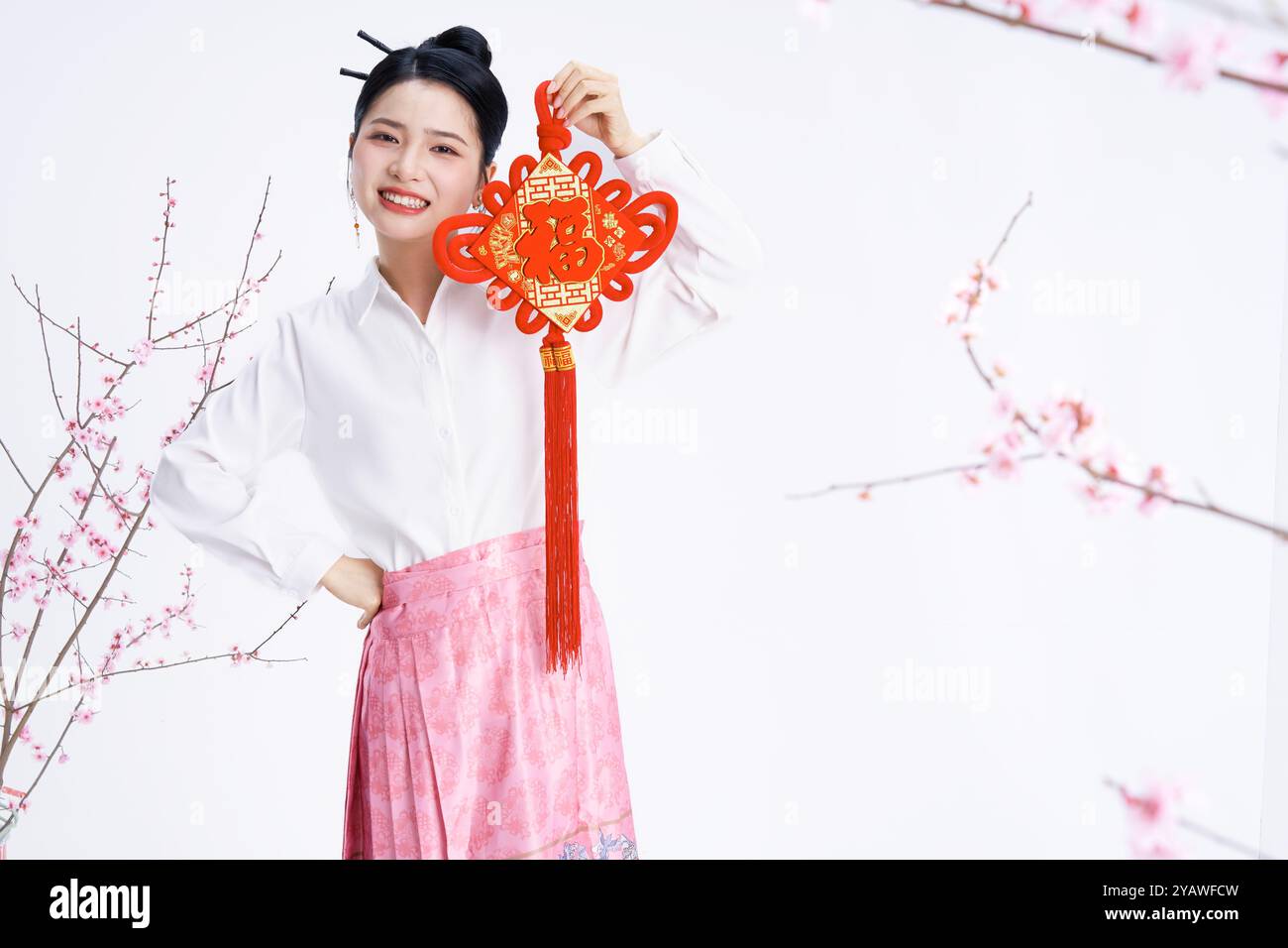 A young Chinese woman drinking tea under a flower tree Stock Photo - Alamy