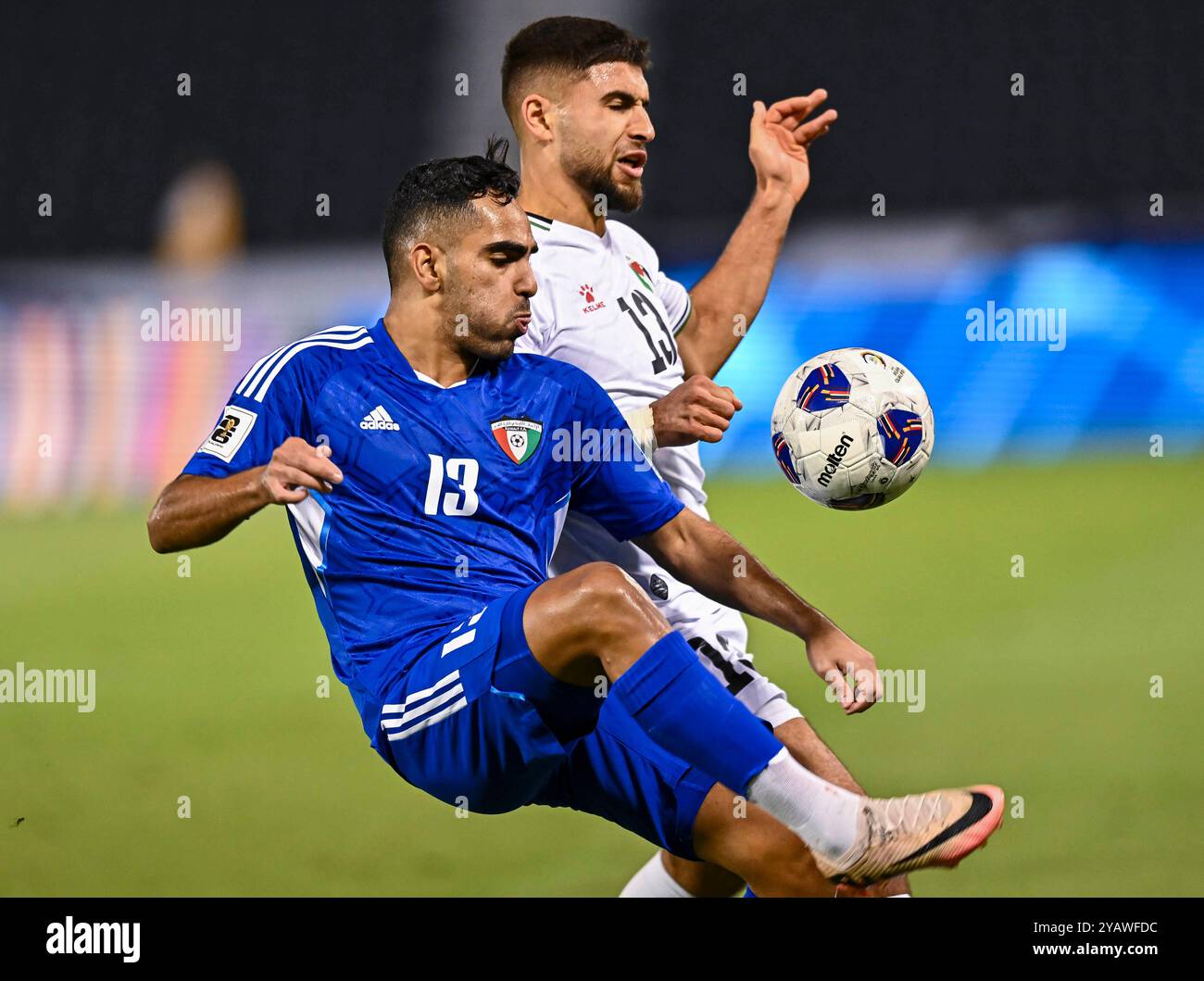 Doha, Qatar. 15th Oct, 2024. Omar Faraj (R) of Palestine vies with Rashed Aldousari of Kuwait ...