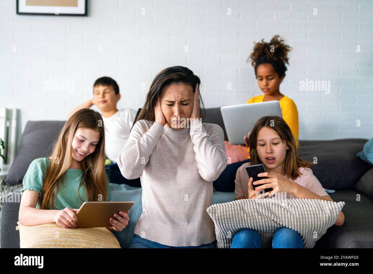 Sad woman with multiethnic children using digital gadgets.. Family and ...