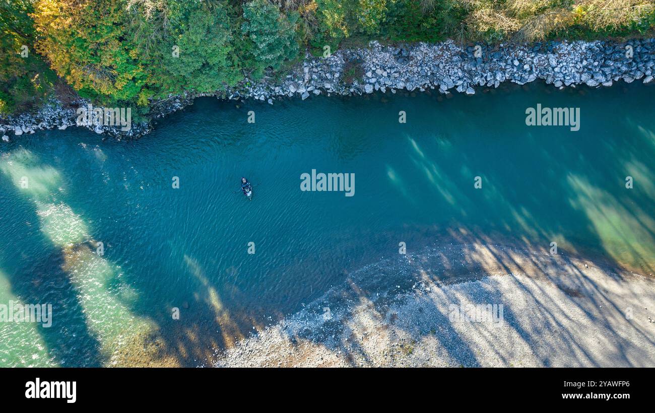 Aerial view of a fishing boat on the blue waters of the Nooksack River ...