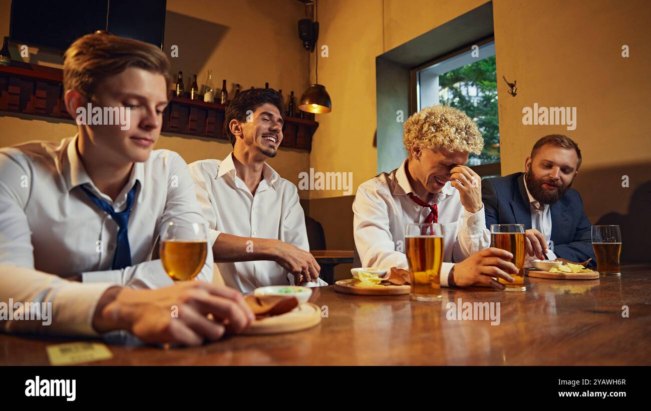 Group of colleagues share hearty laugh at bar, relaxed and enjoying ...