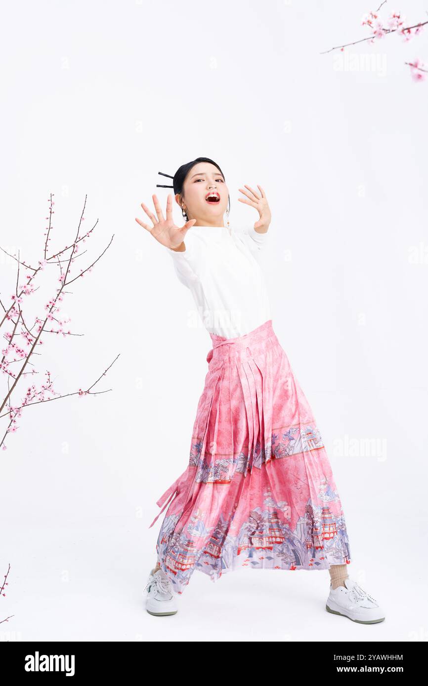 A young Chinese girl dancing in a traditional long dress Stock Photo ...