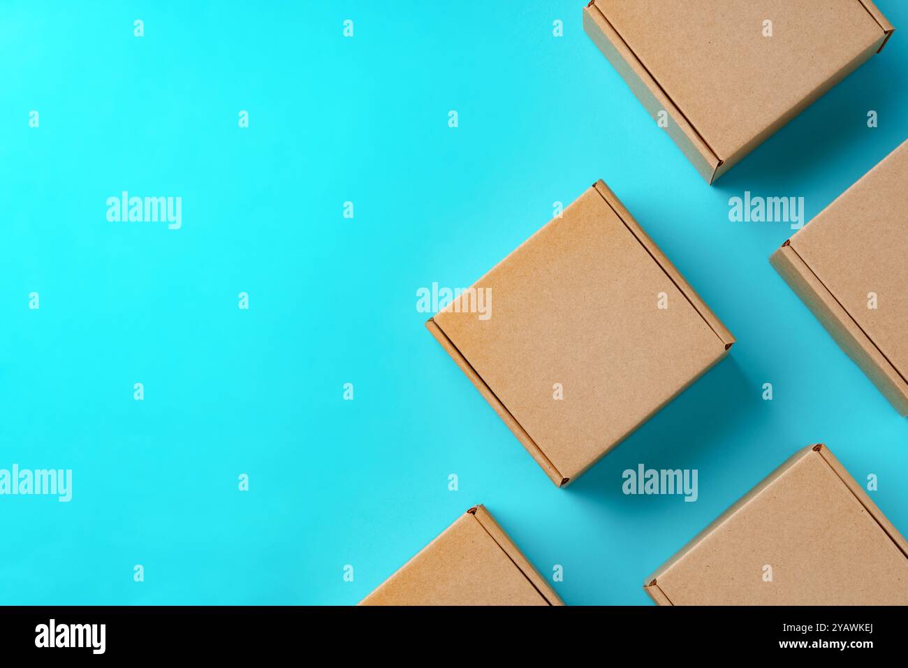 A collection of cardboard boxes arranged on a bright blue surface Stock ...