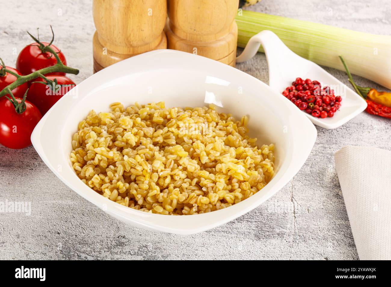 Boiled bulgur wheat in the bowl garnish Stock Photo - Alamy