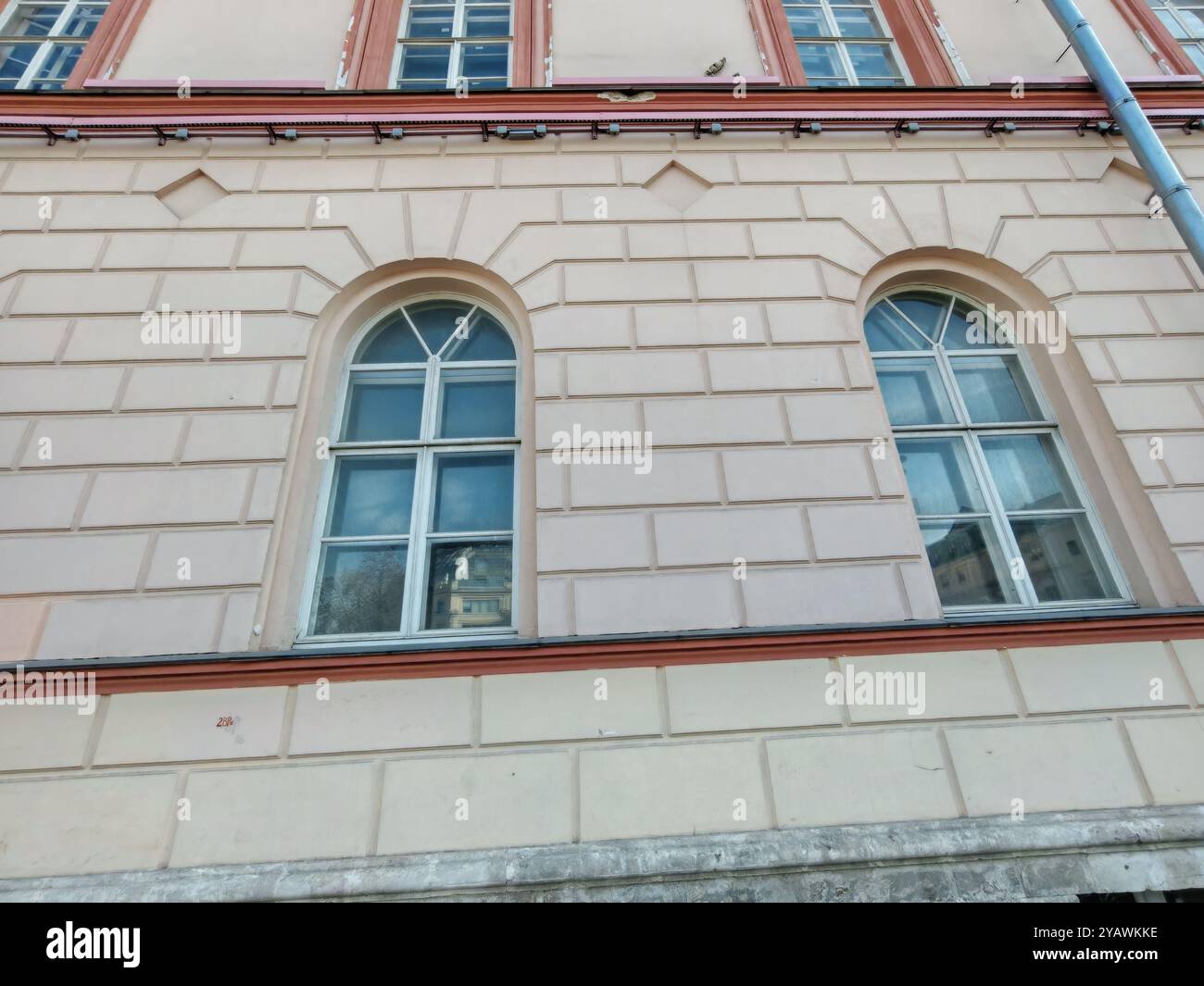 large two-story classical building with ornate detailing, large windows ...