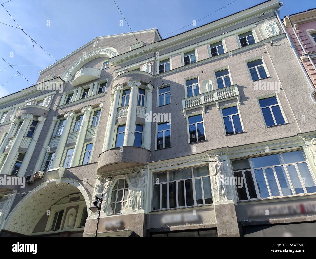 large yellow building with multiple windows and an arched doorway ...