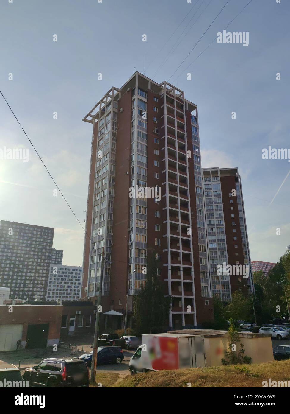 A high-rise residential building featuring a mix of red and beige brick ...