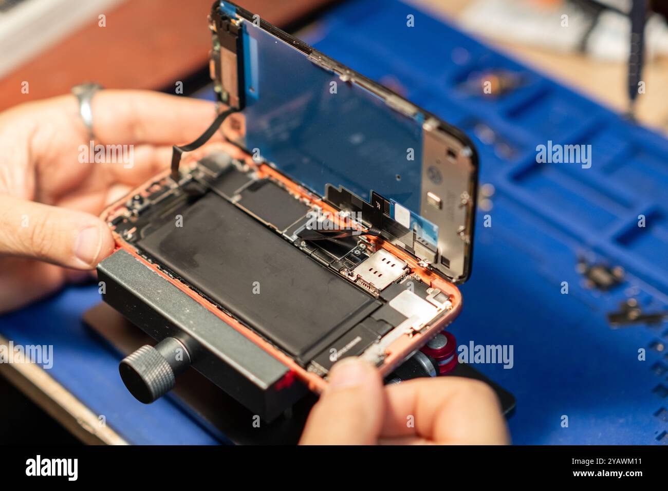 Smartphone battery repair in a tech shop showing detailed disassembly ...