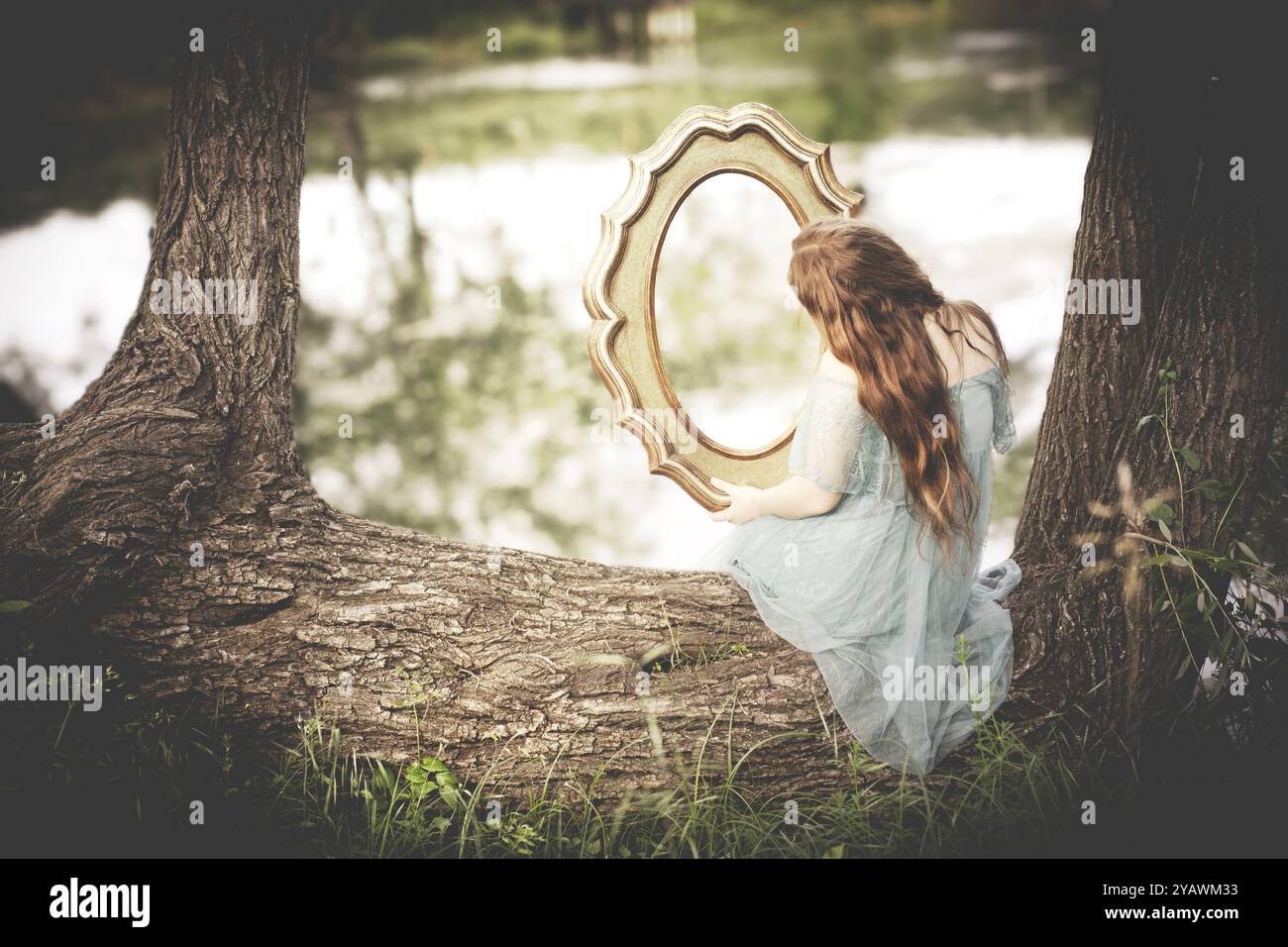 woman looks in a surreal mirror reflecting the nature behind, abstract concept Stock Photo - Alamy