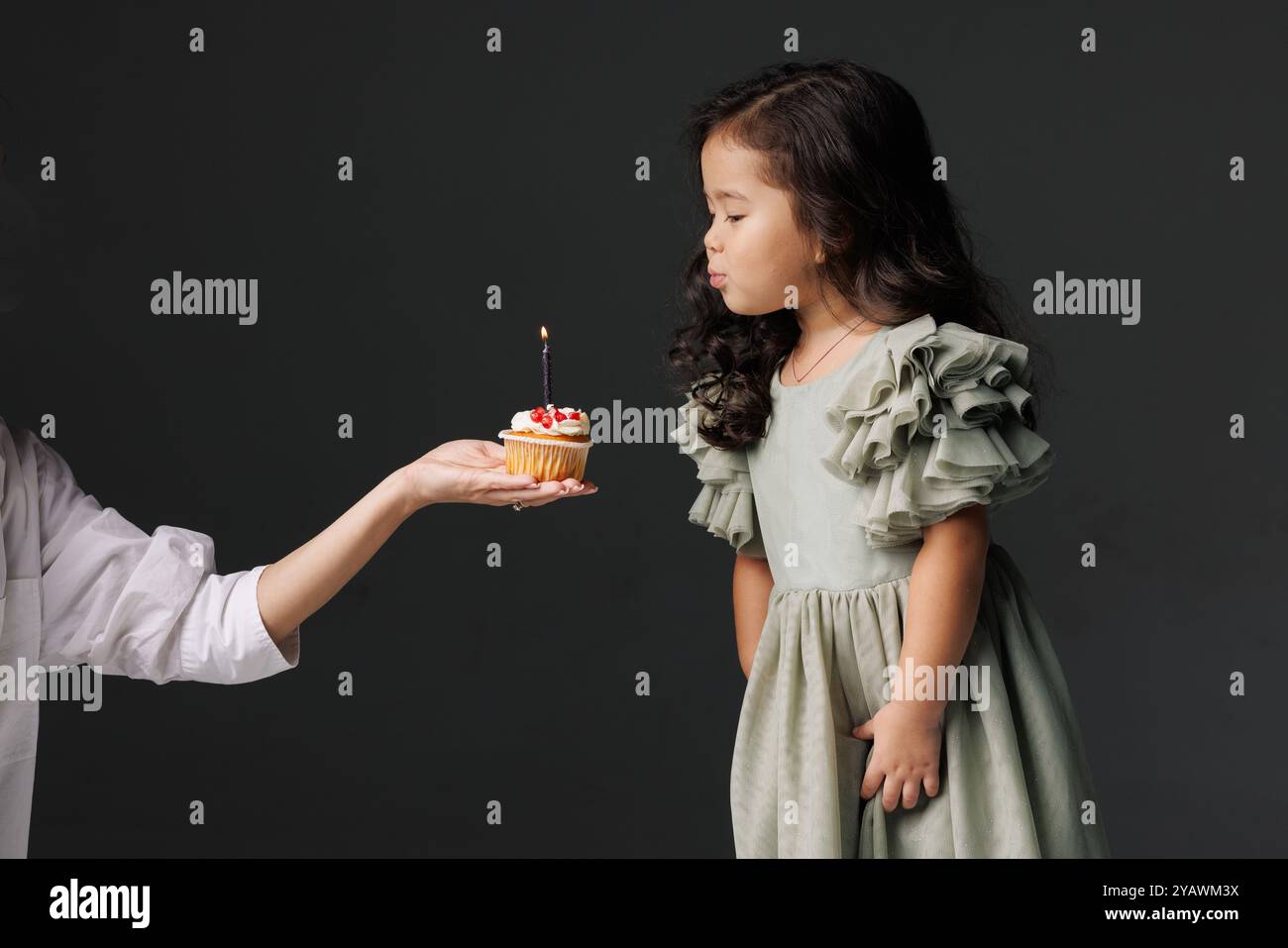 little chinese girl celebrating her birthday, close up hand handing ...