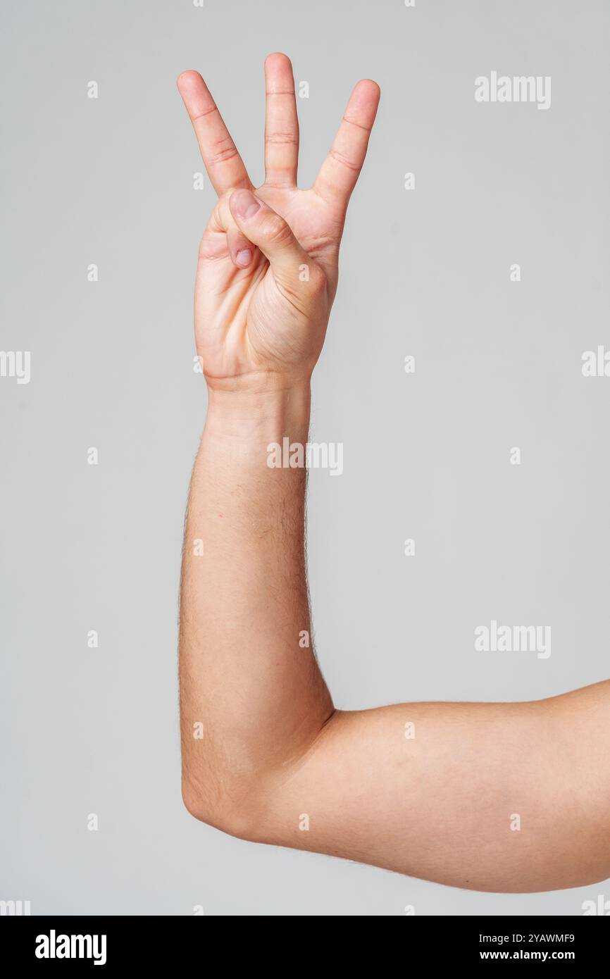 A person hand gesture against a neutral background Stock Photo - Alamy