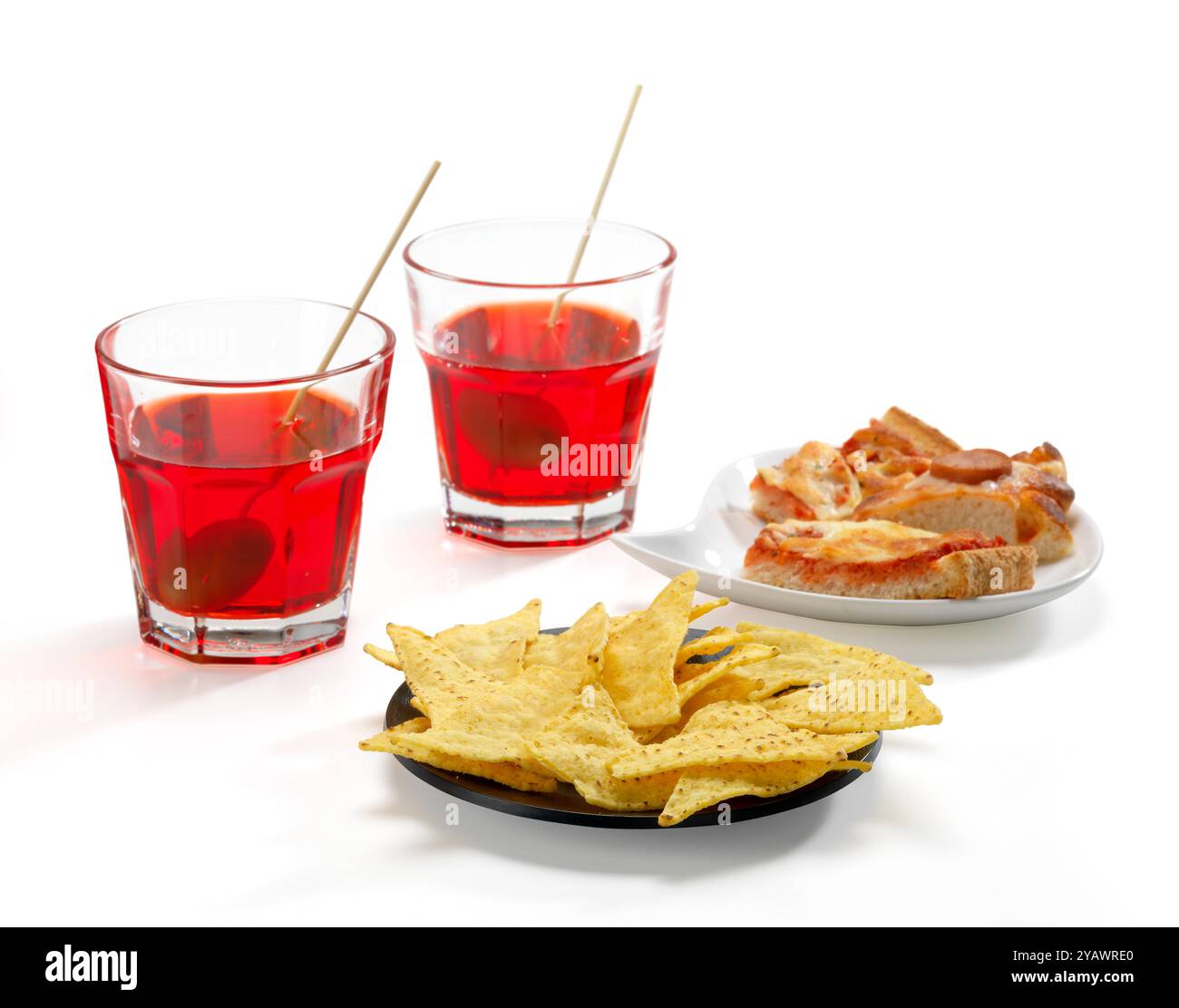 Still life aperitif with drinks and various appetizers, on white ...
