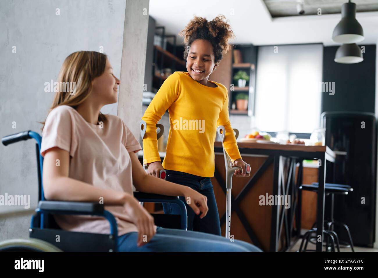 Happy multiethnic children with disability. Wheelchair and crutch Stock ...