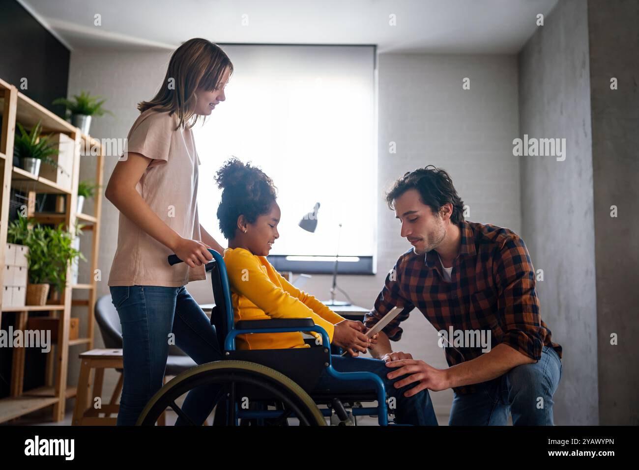 Happy multiethnic family with child with disability in wheelchair Stock ...