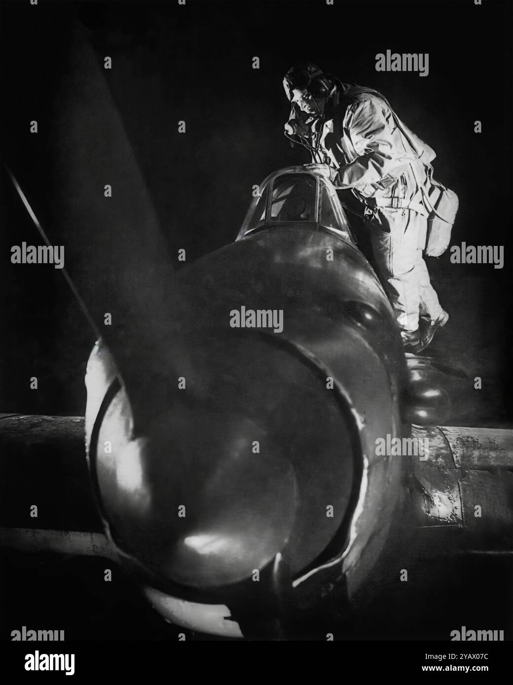 A pilot climbing into a Hawker Hurricane fitted out as a night fighter ...