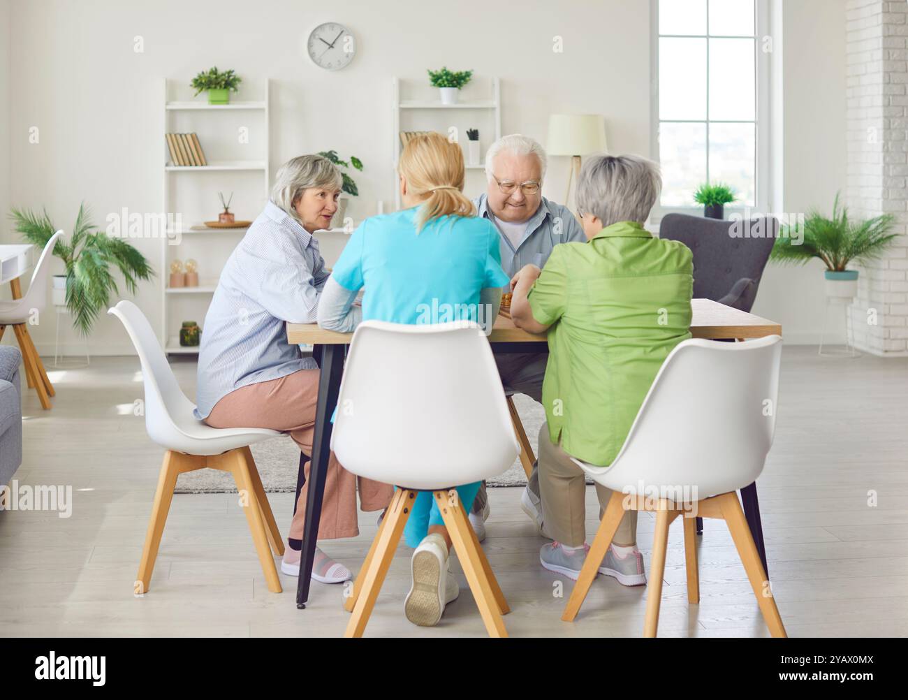 Caregiver Engaging In Conversation With Elderly Patients Stock Photo ...