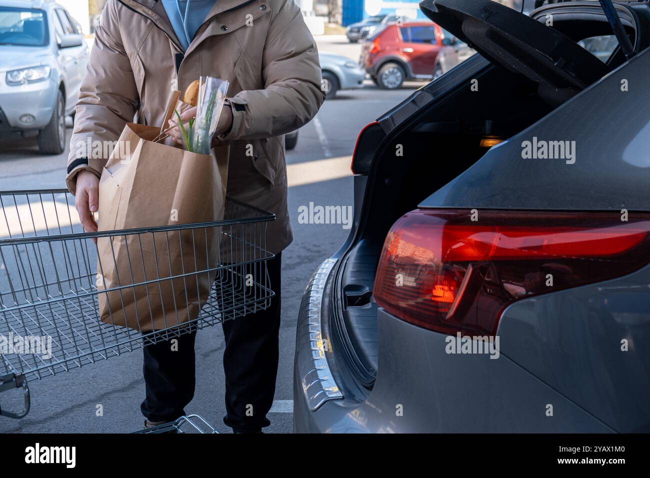 Man Loading Groceries into Car Trunk Stock Photo - Alamy