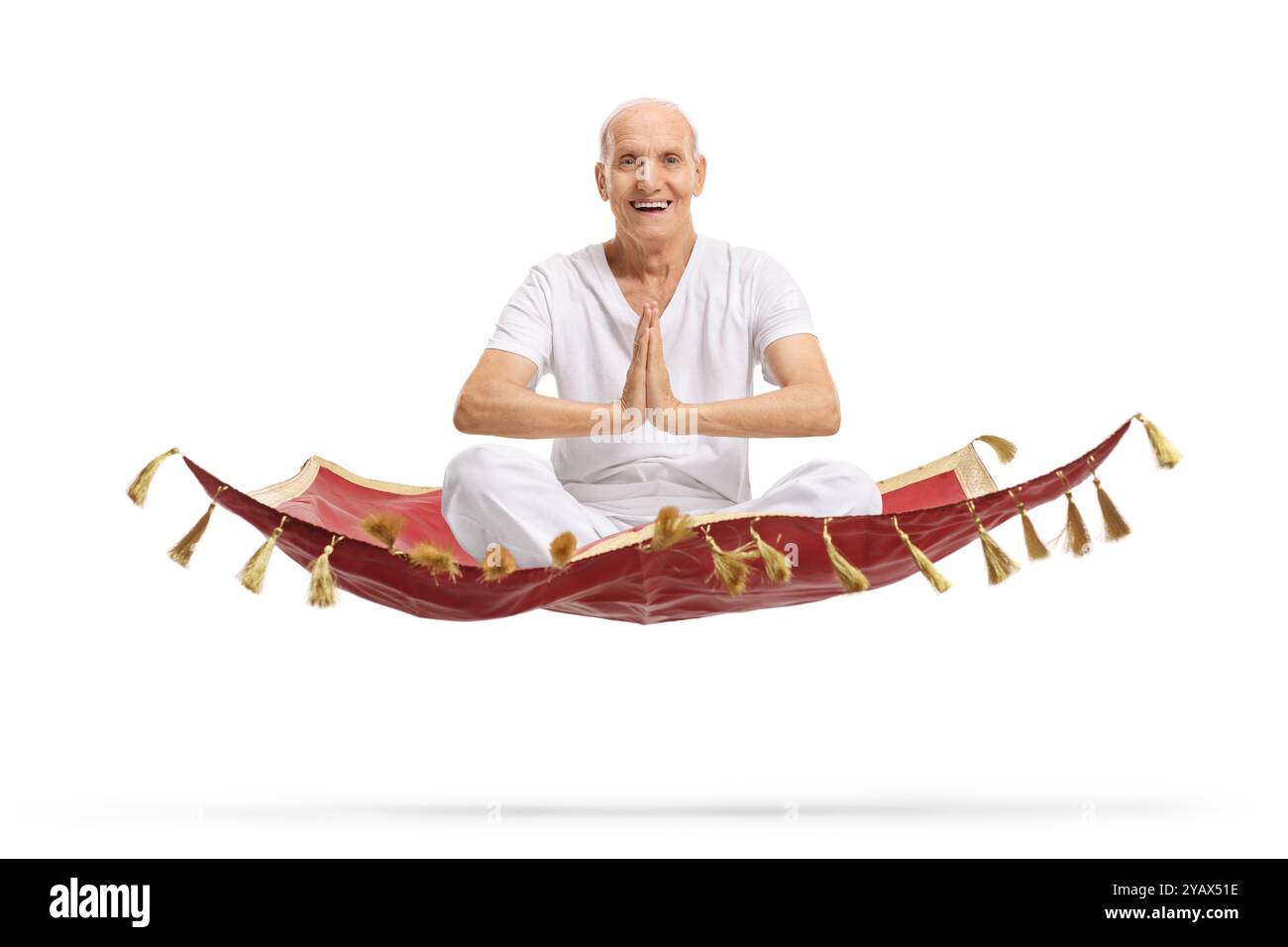 Senior man sitting on a magic carpet and practicing yoga isolated on ...