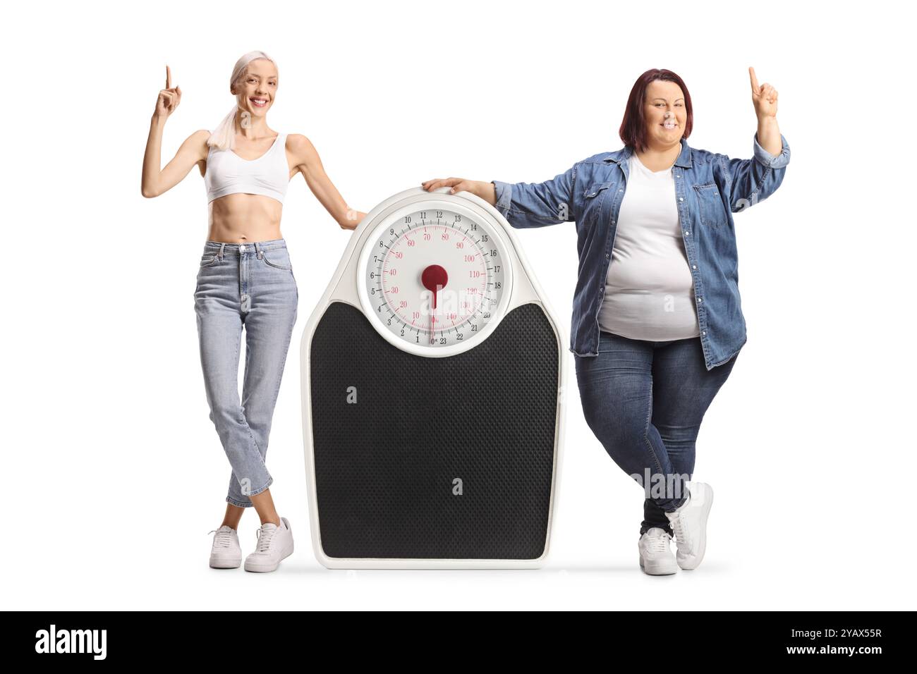 Slim and overweight woman standing next to a weight scale and pointing ...