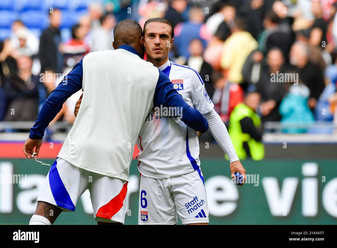 Maxence Caqueret of Olympique Lyon (R) talks with teammate at the end ...